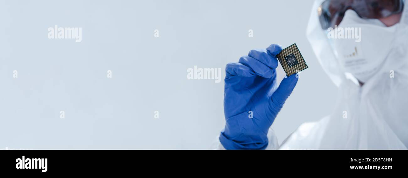Close-up view on a new semiconductor microchip in gloved hand of ...