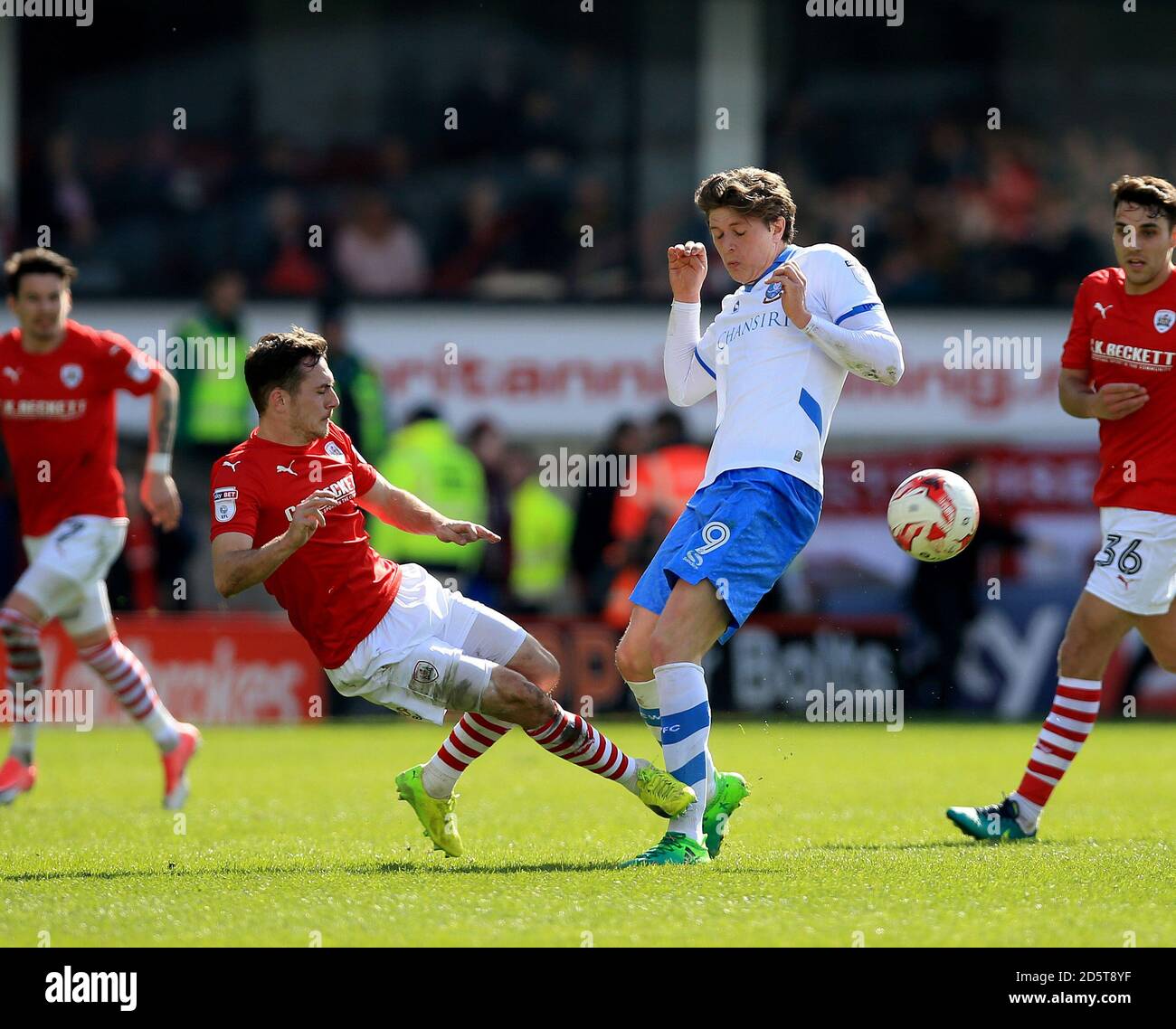 Barnsley's Josh Scowen (Left) tackles Sheffield Wednesday's Adam Reach ...
