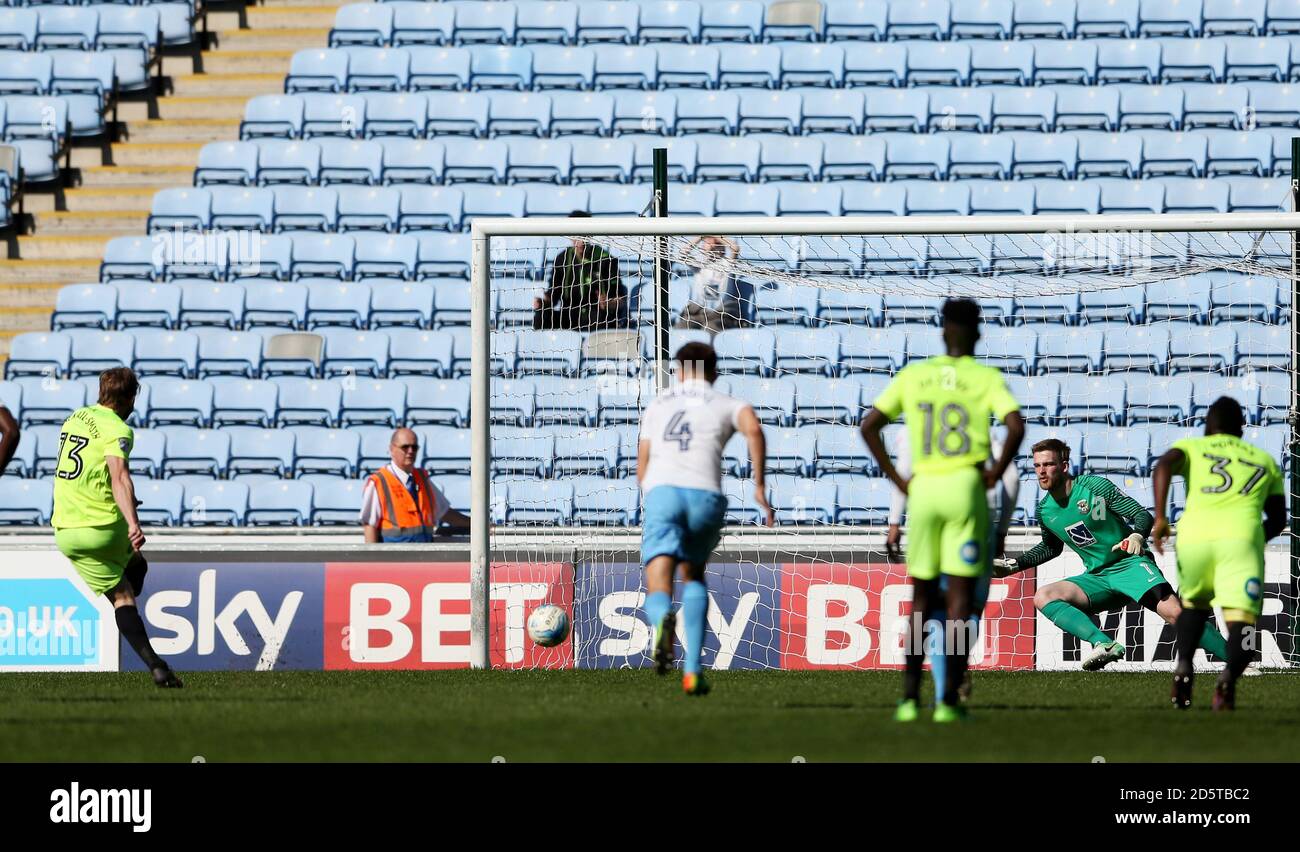 Coventry City's Lee Burge saves a penalty from Peterborough United's ...