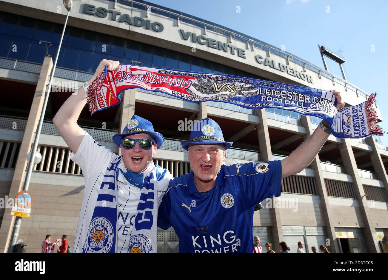 Leicester City fans pose for a picture with their half and half scarf ...