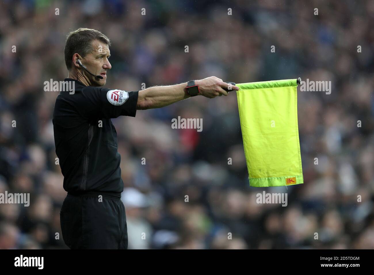 A linesman flags for offside Stock Photo - Alamy