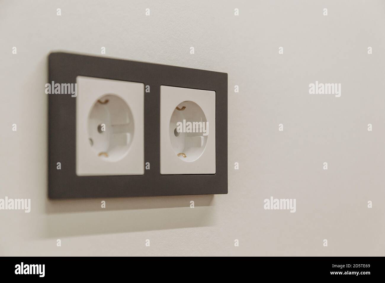 gray electrical outlet on white wall in room Stock Photo - Alamy