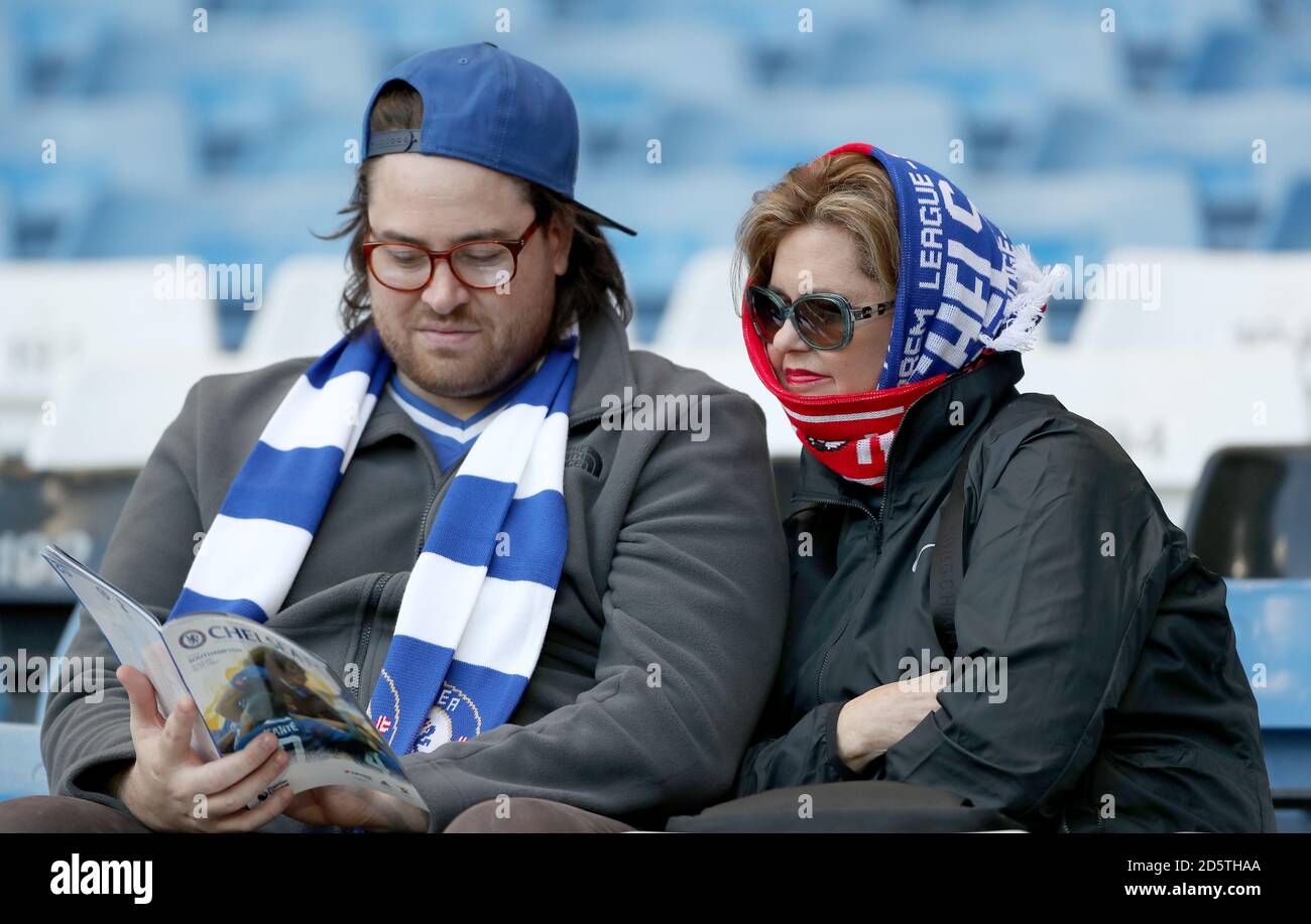 Chelsea fans read the match day programme before kick off Stock Photo ...