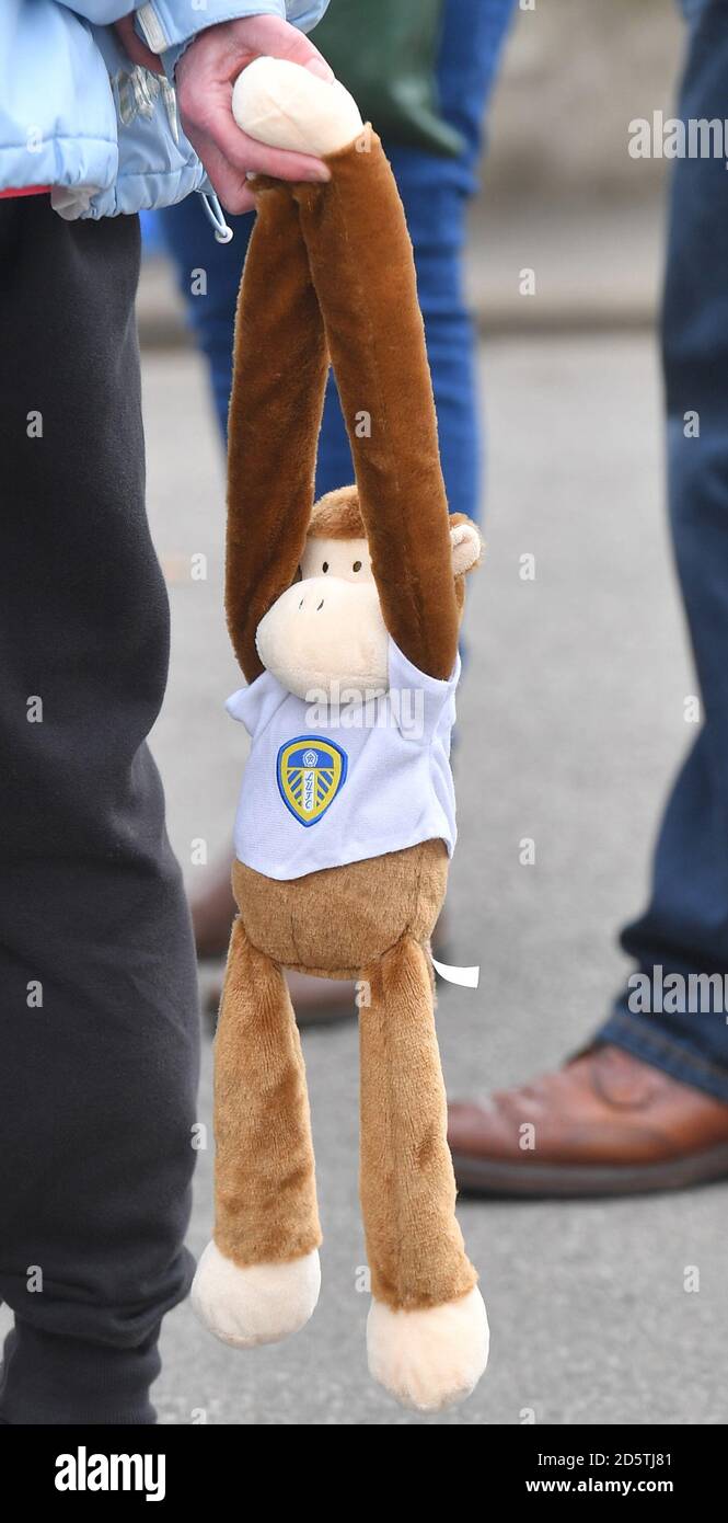 A fan carries a Leeds United cuddly toy monkey Stock Photo - Alamy