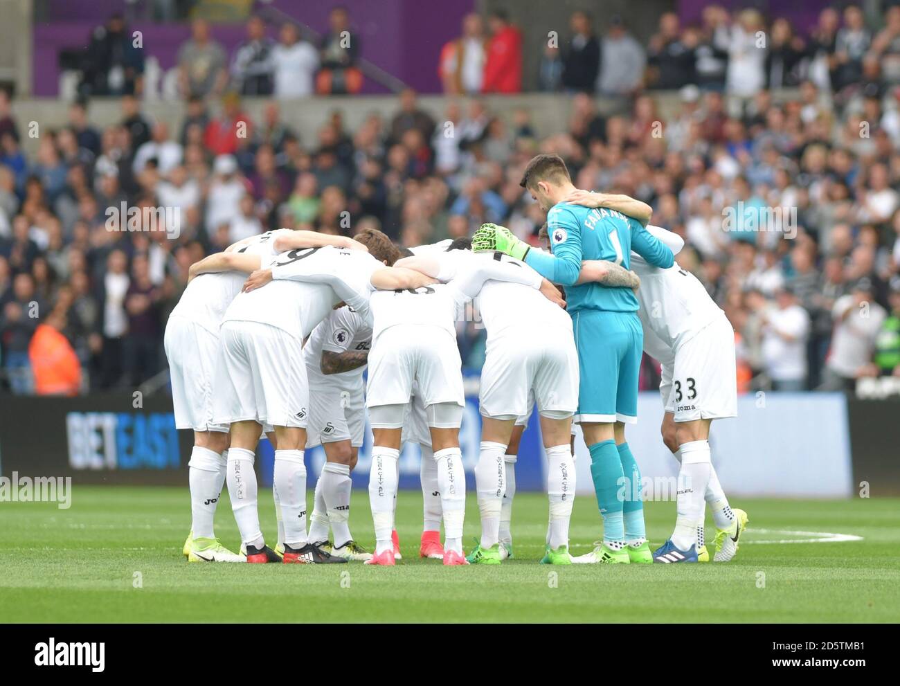 Swansea players huddle before the game Stock Photo - Alamy