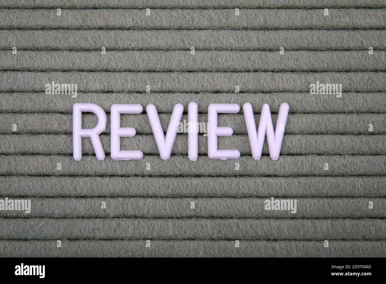 REVIEW. White letters of the alphabet on a green background. Text and ...