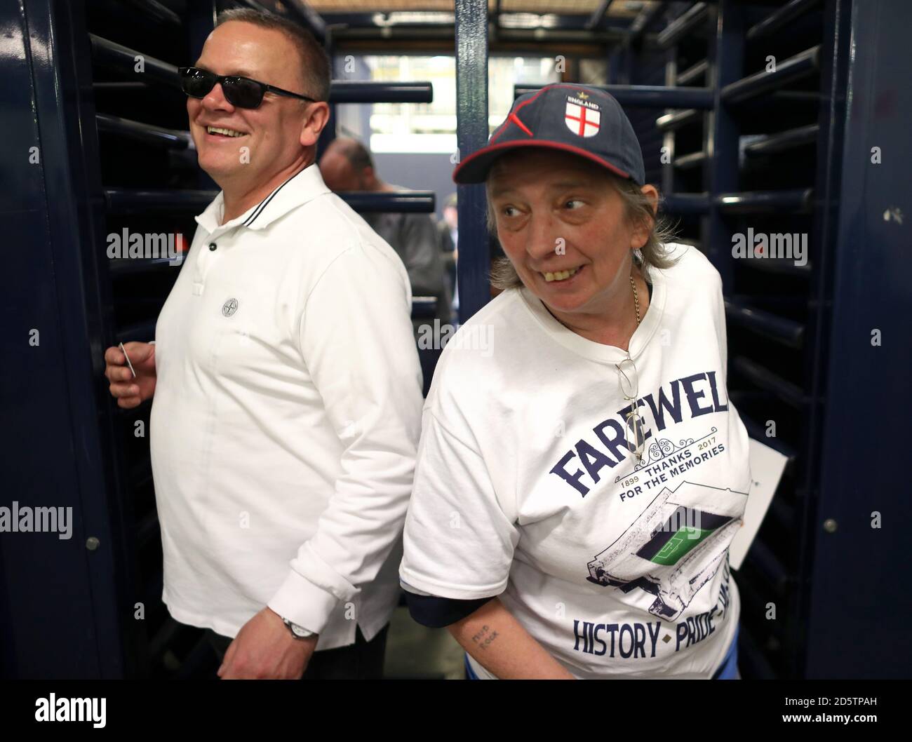 Fans walk through the turnstiles Stock Photo - Alamy