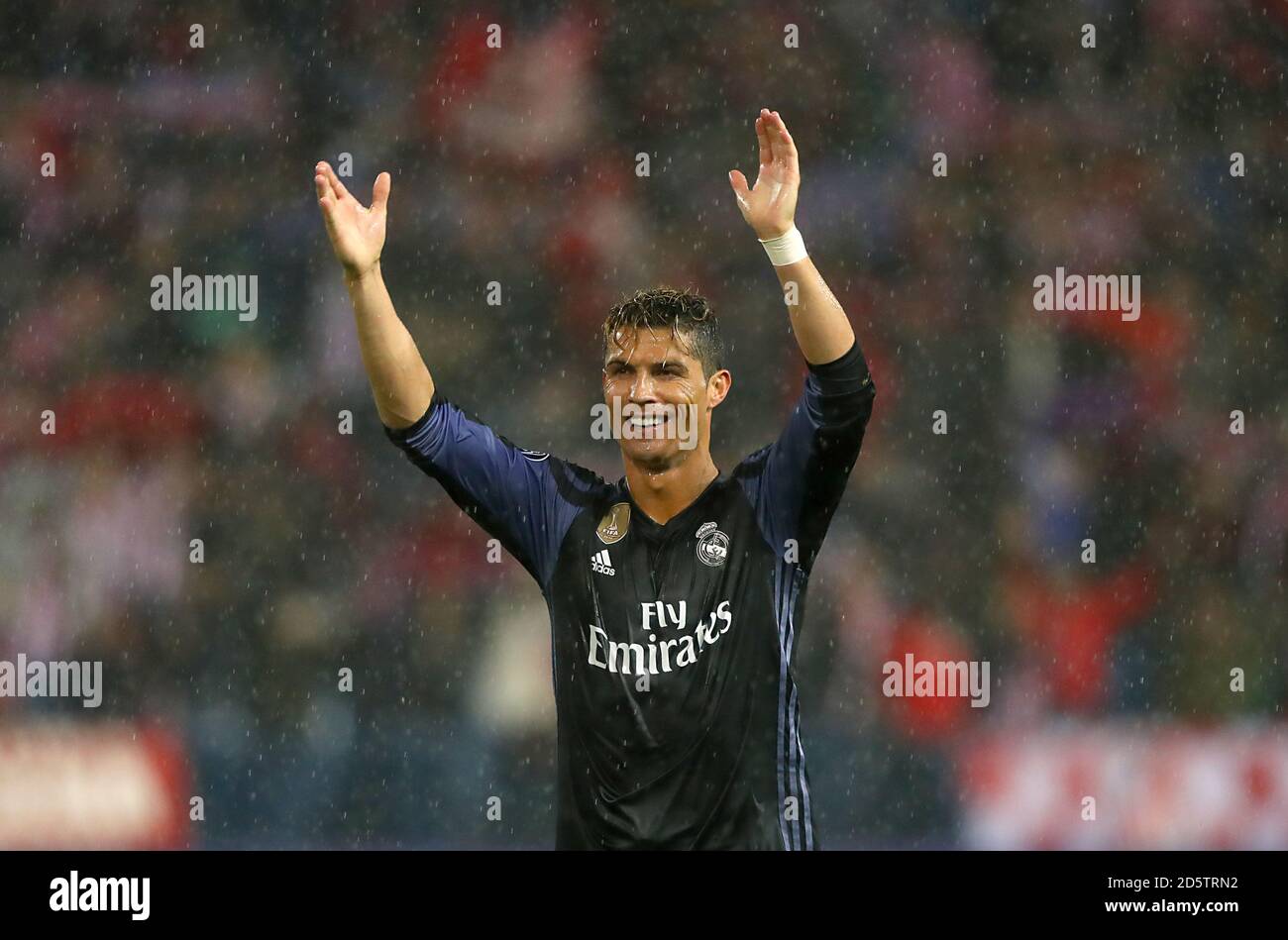 Real Madrid's Cristiano Ronaldo celebrates in the rain after the game ...