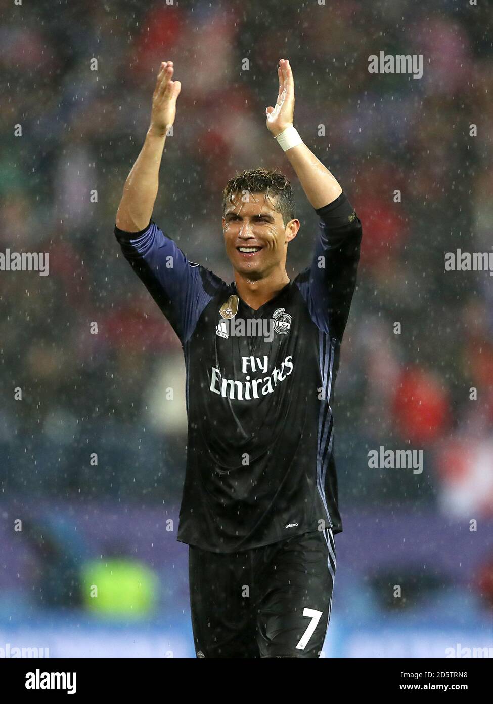 Real Madrid's Cristiano Ronaldo celebrates in the rain after the game ...