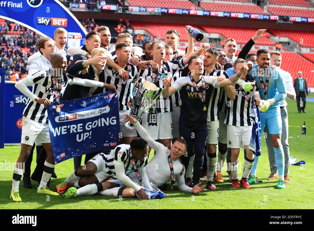 Millwall players celebrate with the Sky Bet League One Play Off Trophy ...