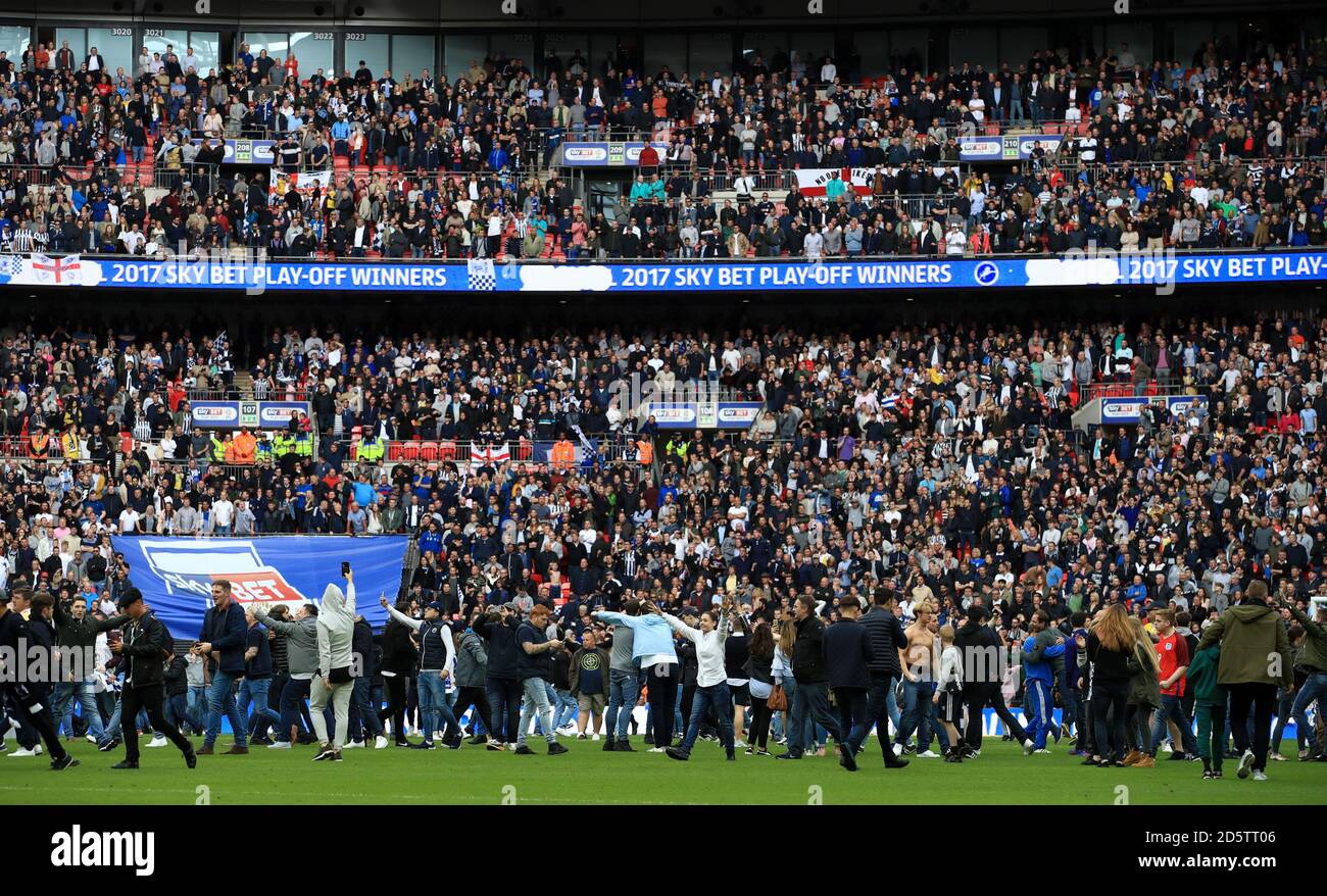 Millwall supporters invade the pitch in celebration after the final ...