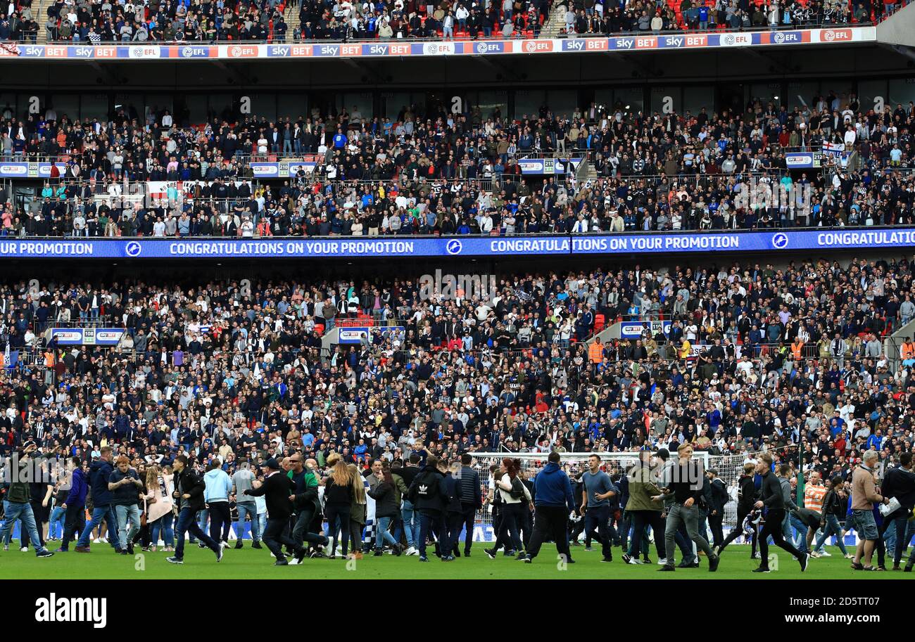 Millwall supporters invade the pitch in celebration after the final ...