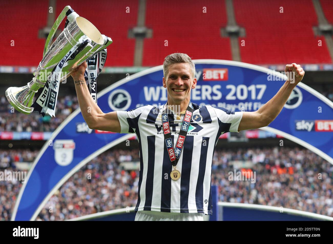 Millwall's Steve Morison celebrates with the trophy on the pitch after ...