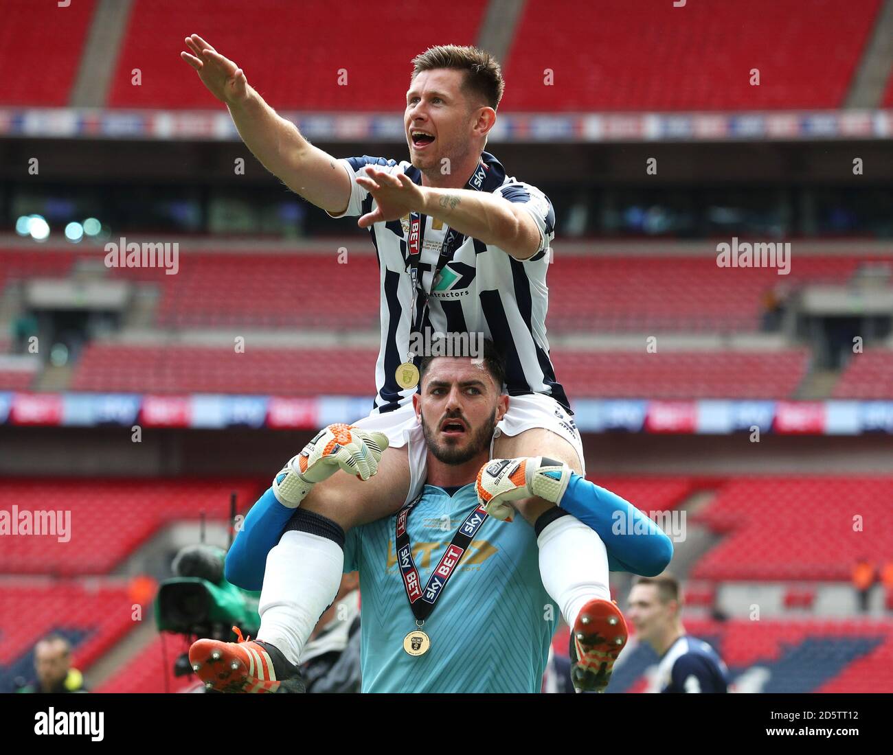 Millwall's Calum Butcher (top) and goalkeeper Tom King celebrate on the ...