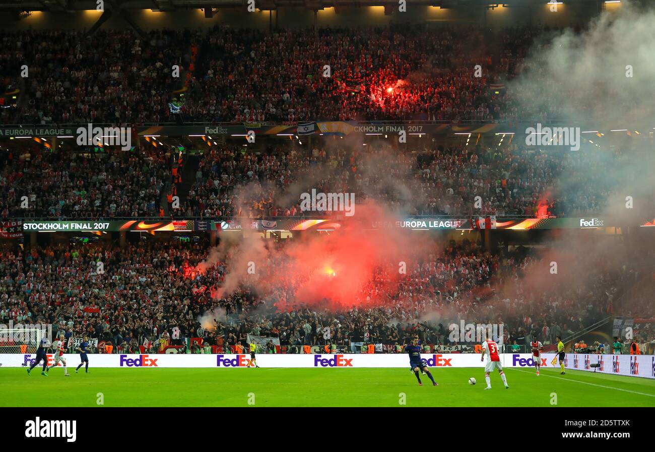 Fans let off flares in the stands during the UEFA Europa League Final ...