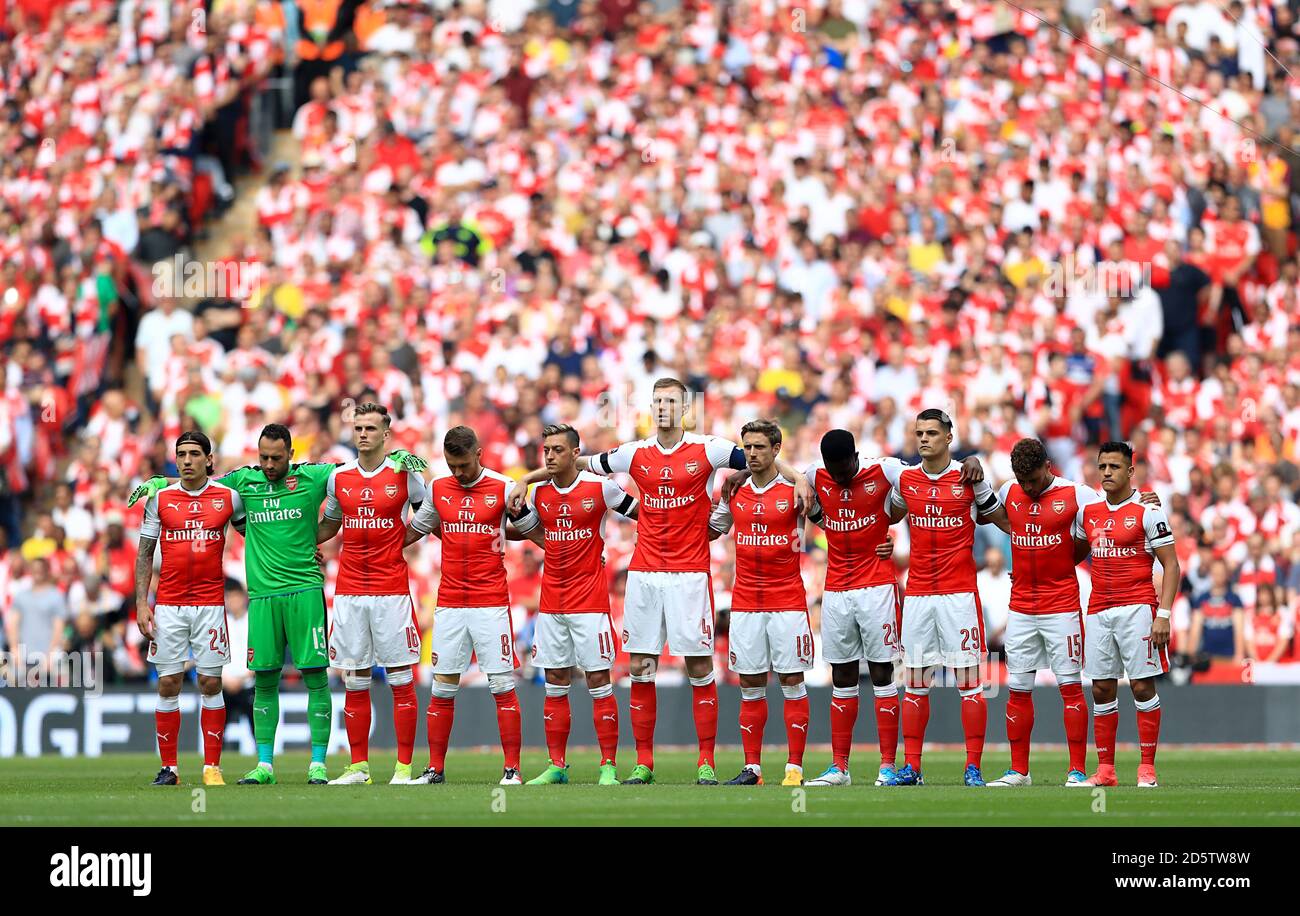 Arsenal players line up for a minutes silence in tribute to the victims ...