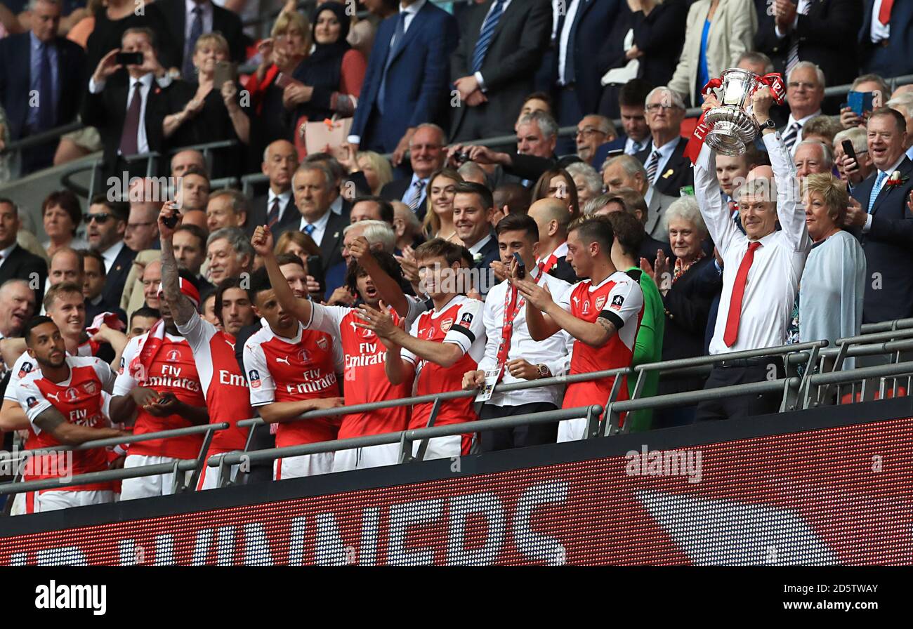 Arsenal manager Arsene Wenger lifts the trophy after winning the FA Cup ...