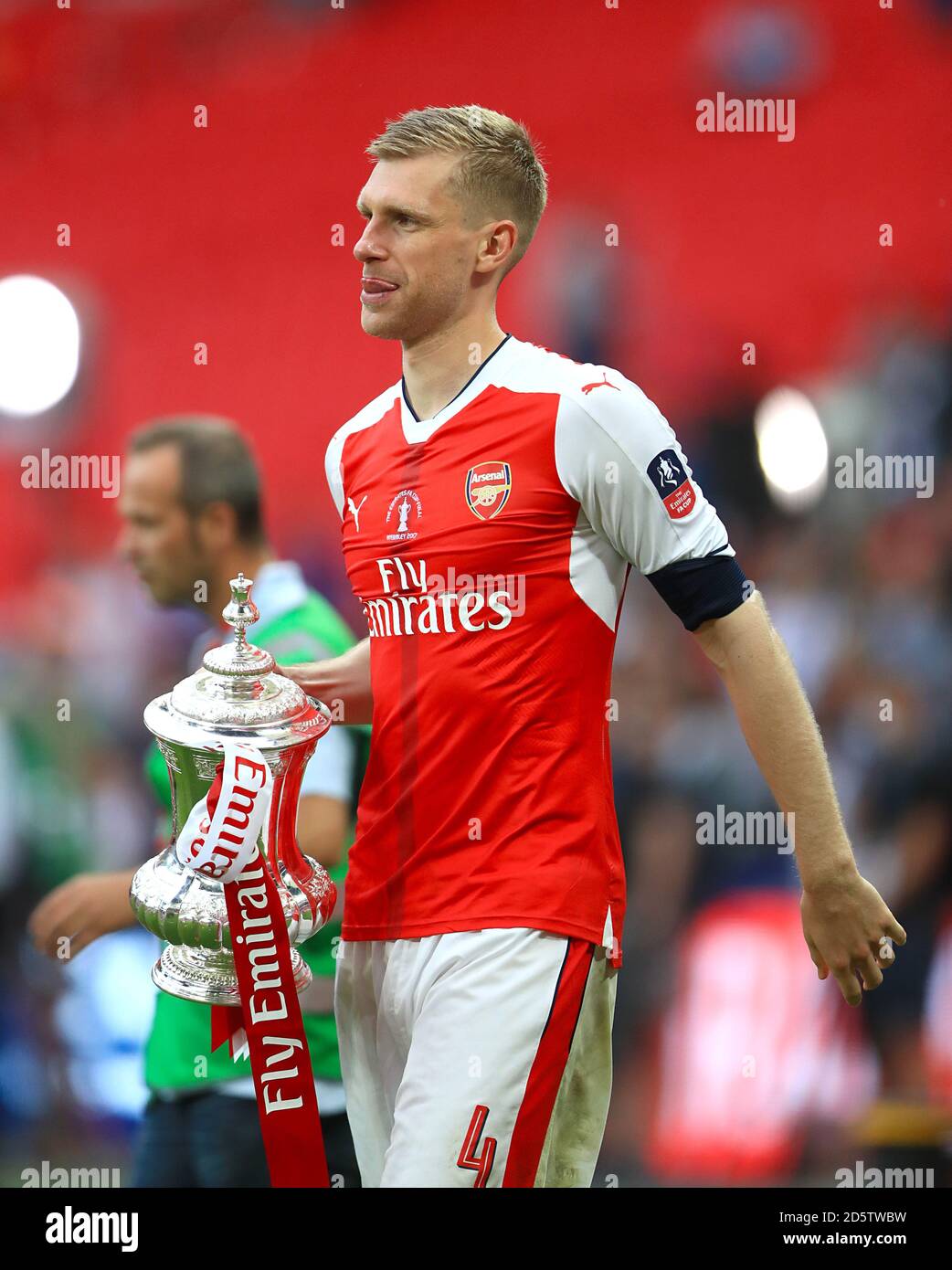 Arsenal's Per Mertesacker celebrates on the pitch after his side win ...