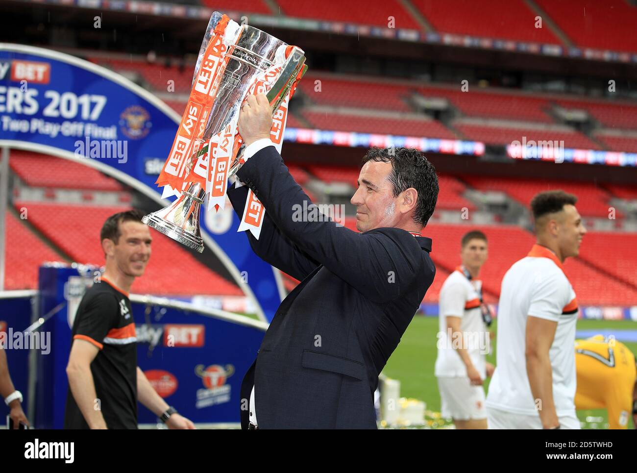 Blackpool manager Gary Bowyer lifts the trophy after the final whistle ...