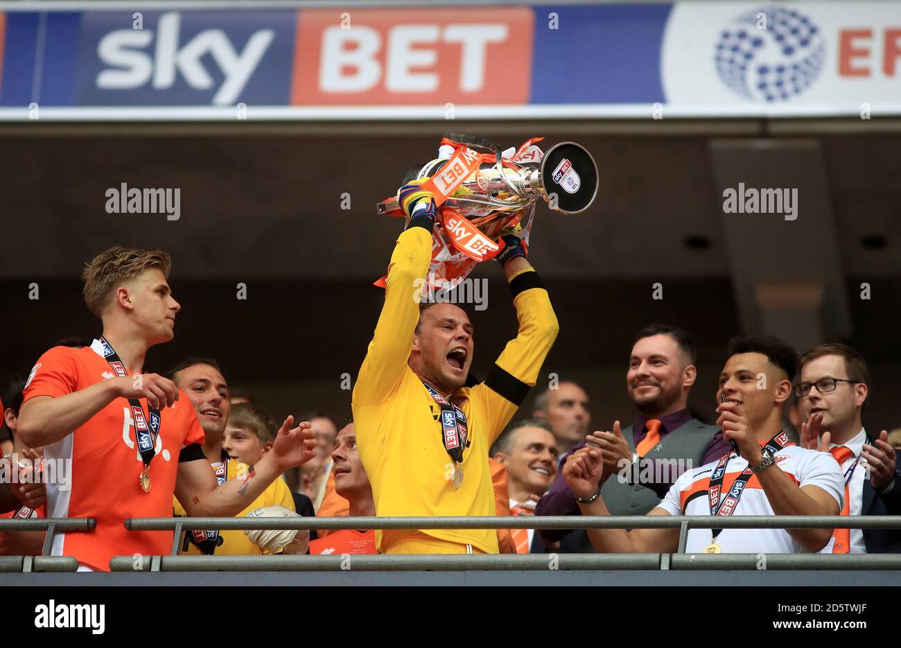 Blackpool goalkeeper Sam Slocombe lifts the trophy after the final ...