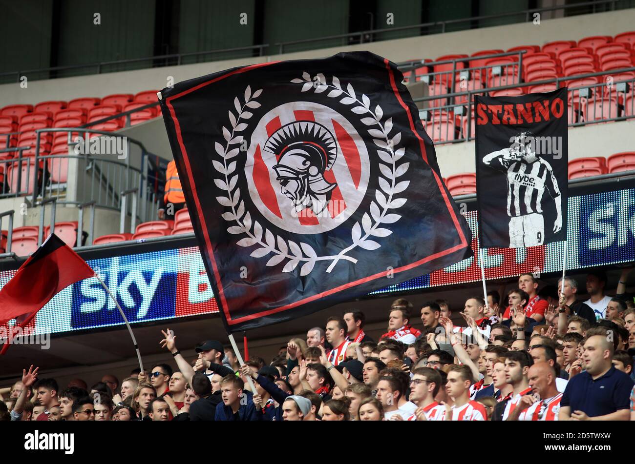 Exeter City fans wave a flag in the stands Stock Photo - Alamy