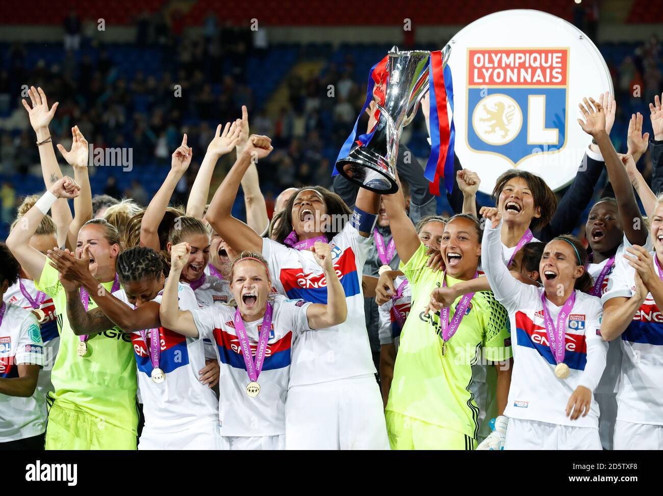 Lyon captain Wendie Renard (centre) lifts the trophy with ehr team ... Lyon captain Wendie Renard (centre) lifts the trophy with ehr team ...