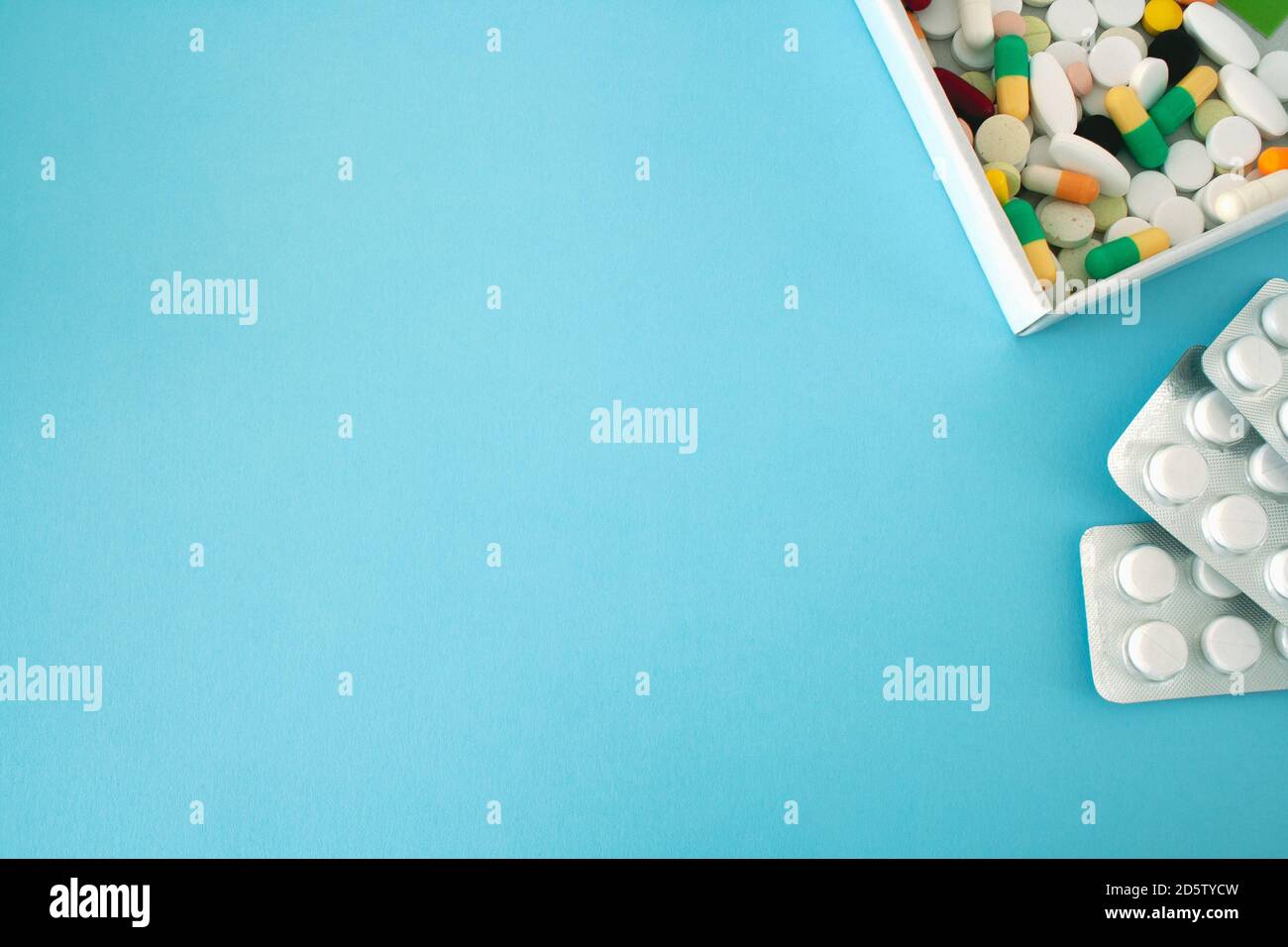 colorful tablets and capsules in a white box, tablets in a package, are ...