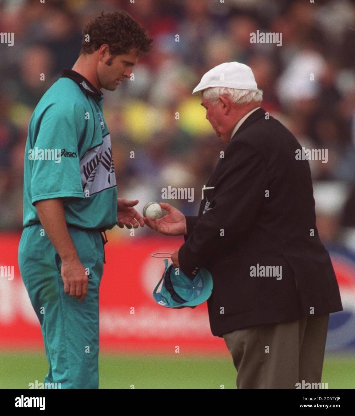 New Zealand's Chris Cairns talks with umpire David Shepherd about the ...