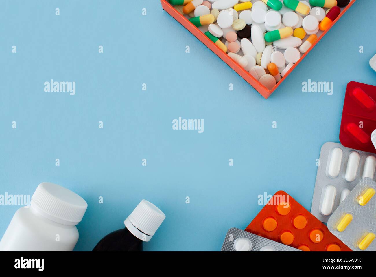 colorful tablets and capsules in an orange box, antiseptic bottle ...