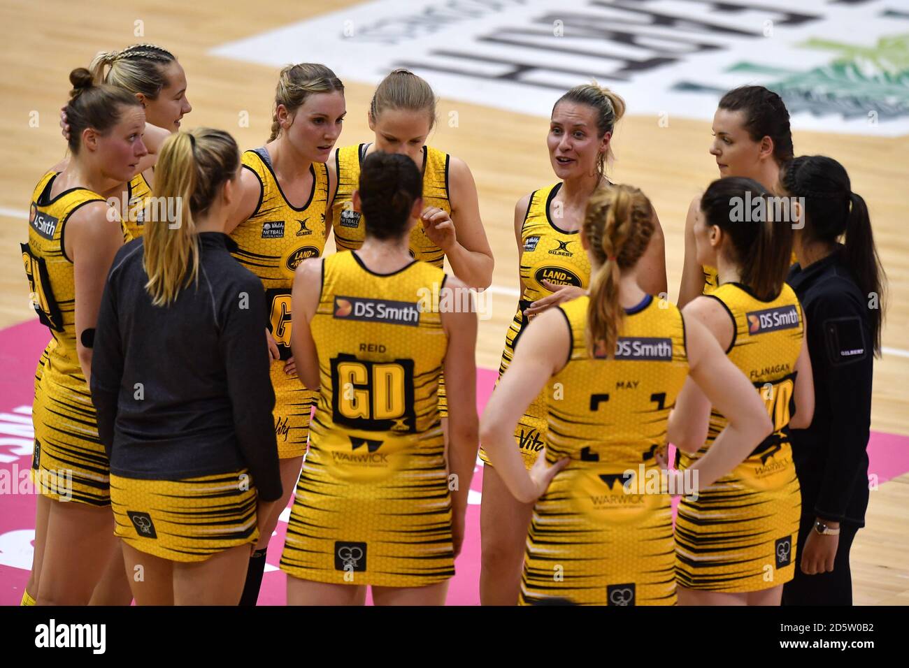 Wasp Netball players during a break in play Stock Photo - Alamy