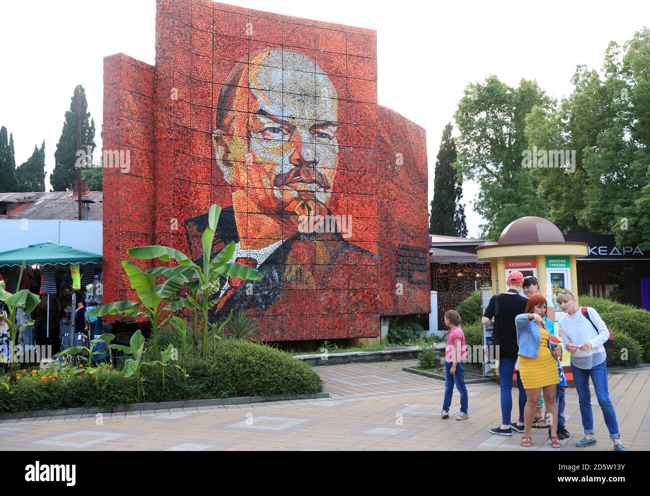 Local people below a portrait of Lenin Stock Photo - Alamy
