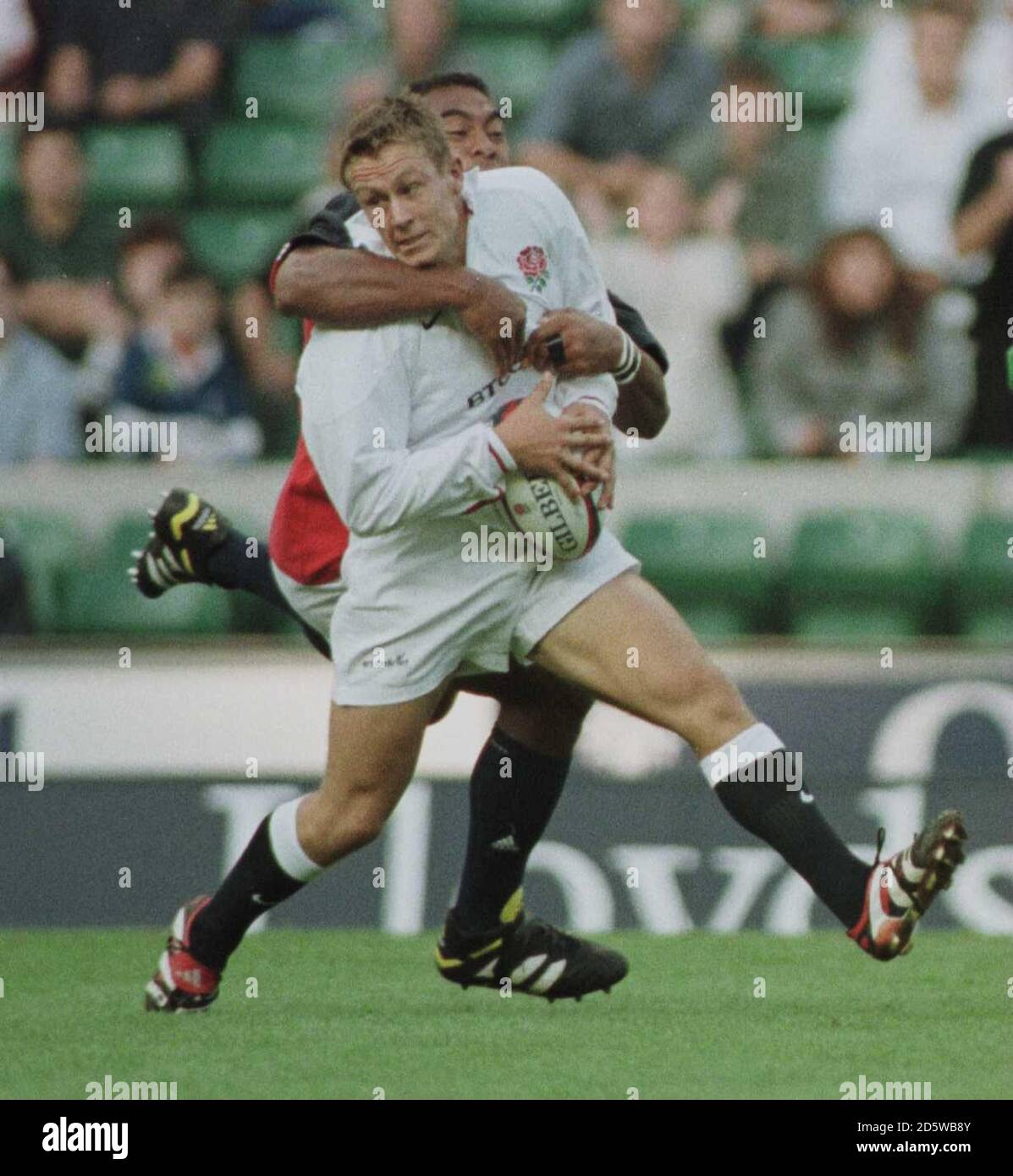 America's David Niu hangs onto England's Jonny Wilkinson as they make ...