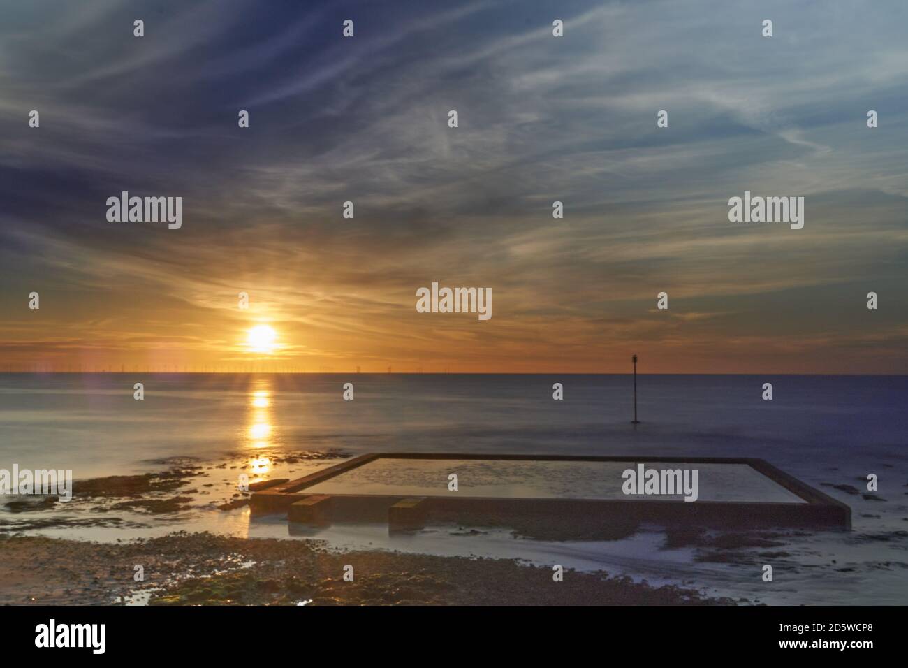 Beautiful view of a calm sea with the reflection of a bright sun on the ...