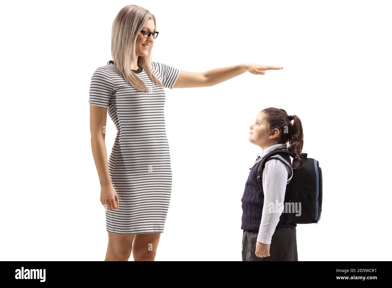 Young woman gesturing with hand and showing the height of a schoolgirl ...