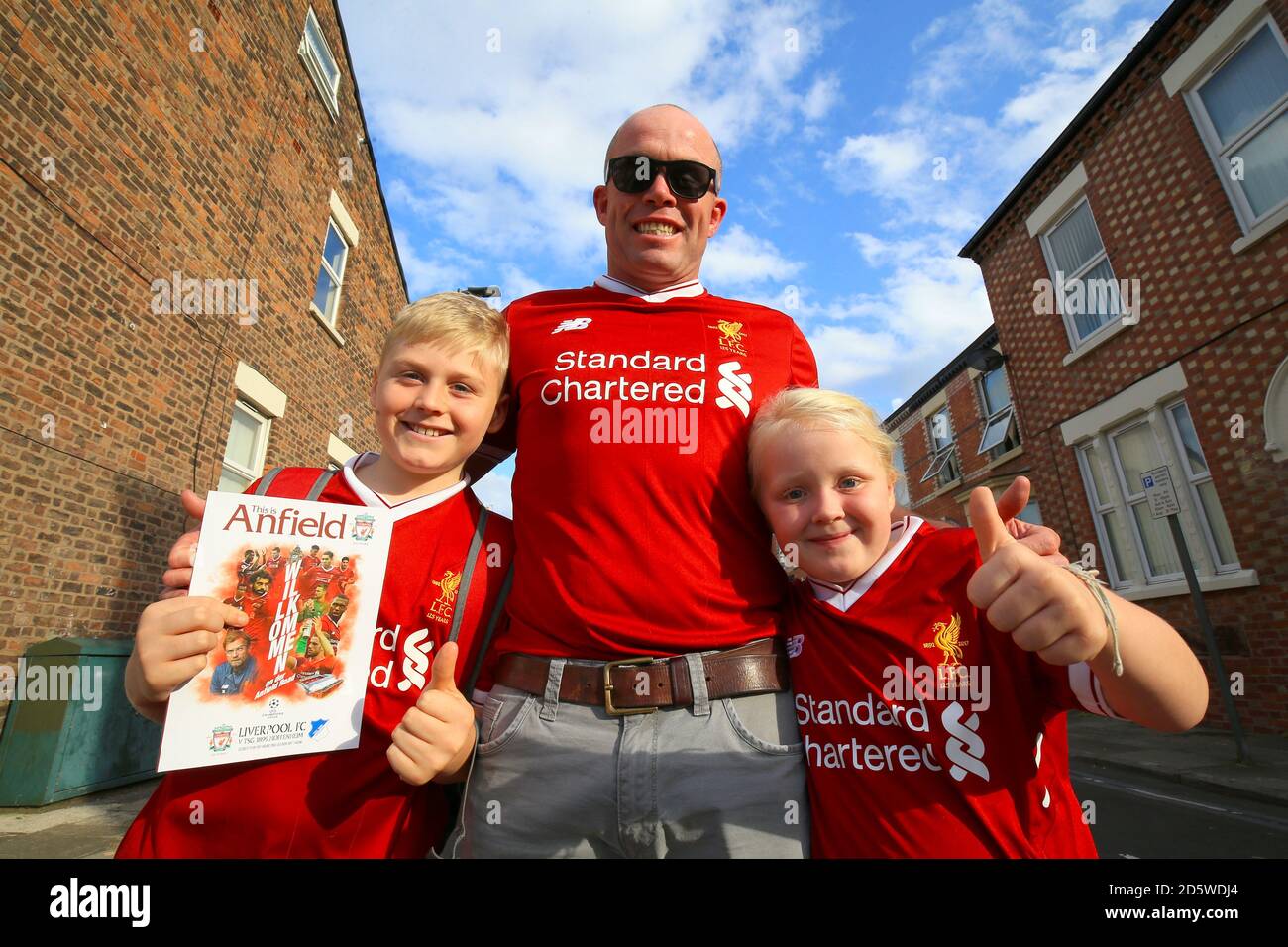 Liverpool fans Harvey, John and Gracie Bowen ahead of the match Stock ...