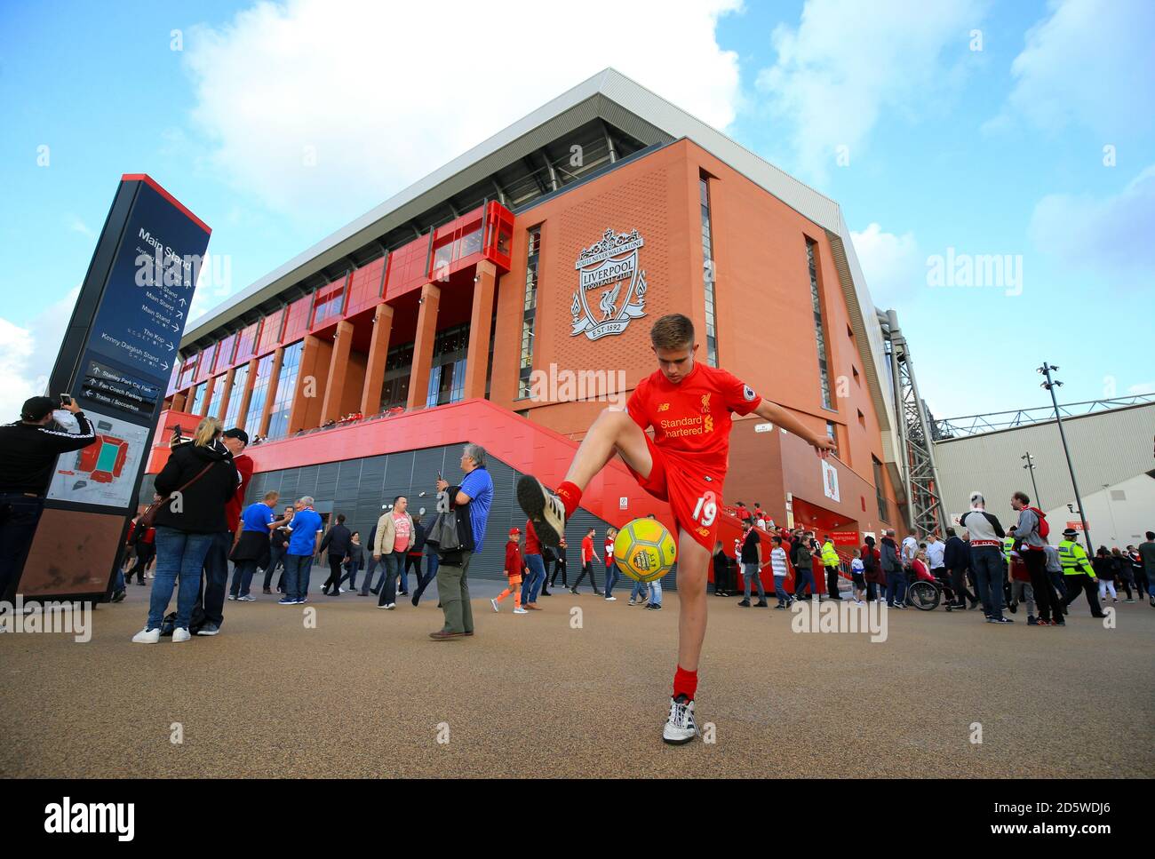 Liverpool fan Ethan Cox practices his football skills outside the ...