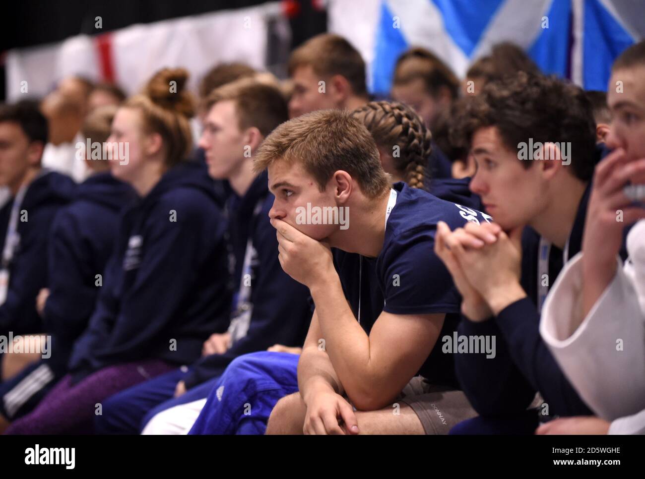 Competitors watch their team mates in action during the Judo ...