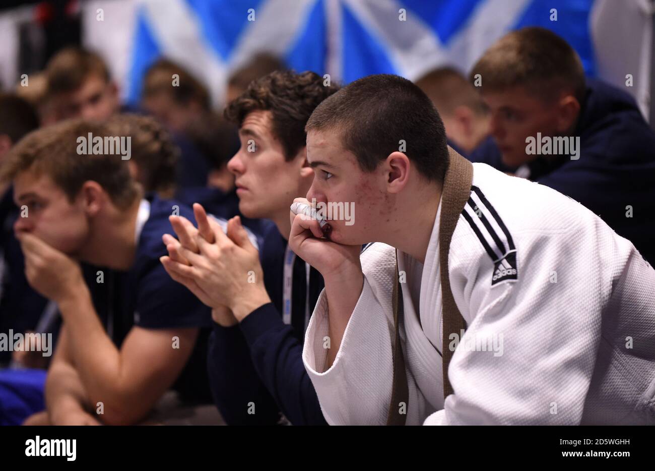 Competitors watch their team mates in action during the Judo ...