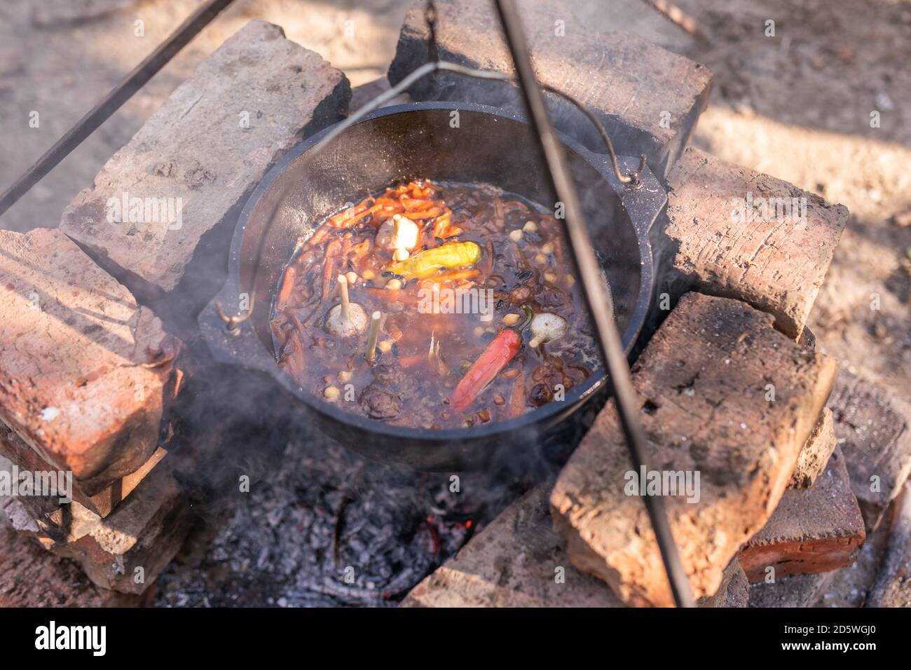 Preparation of raditional armenian pilaf in a cauldron on an open fire ...