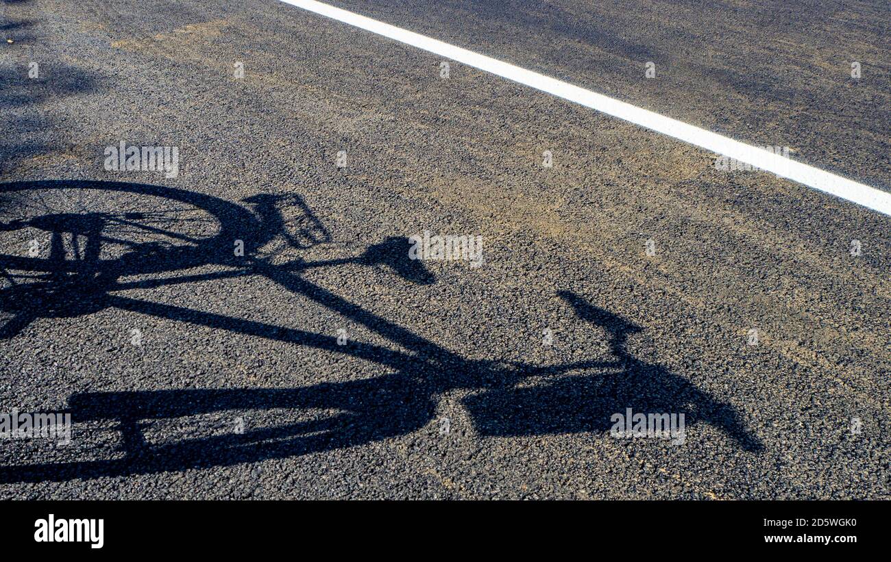 bike silhouette and shadow, bike shadow on asphalt road Stock Photo - Alamy