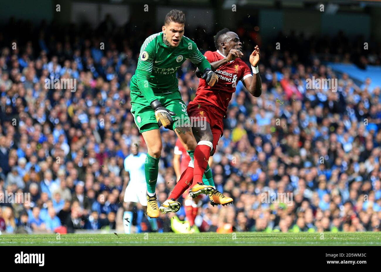 Liverpool's Sadio Mane (right) collides with Manchester City goalkeeper ...