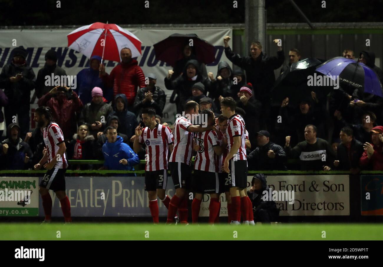 Lincoln City's Harry Anderson celebrates with his team mates after he ...