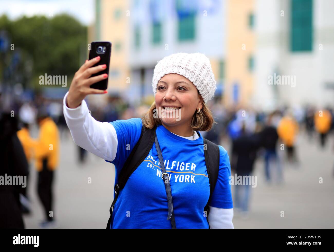 A fan poses for a selfie outside the ground Stock Photo - Alamy