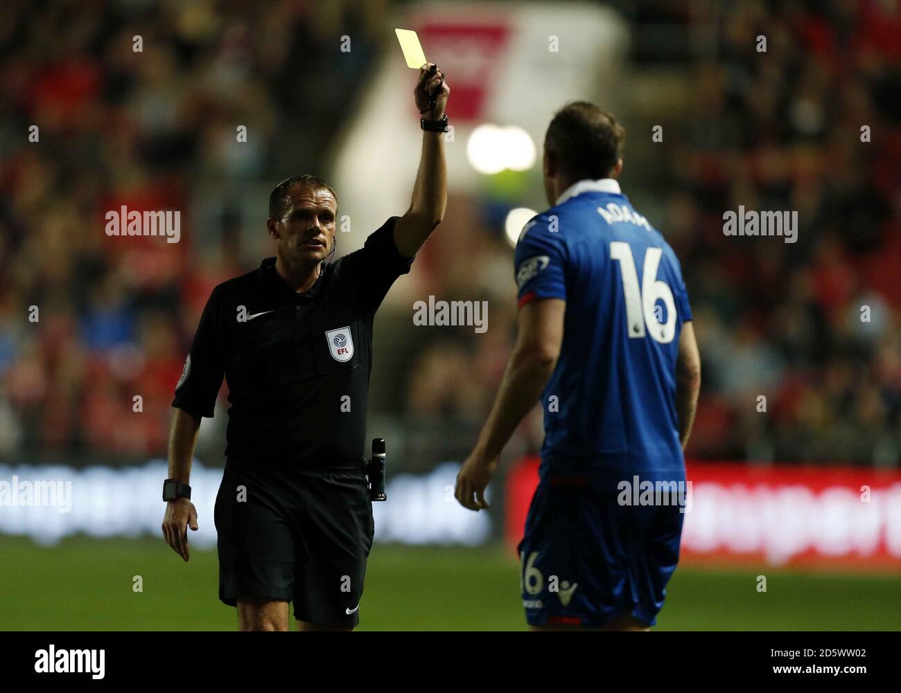 Stoke City's Charlie Adam is shown a yellow card by referee Geoff ...
