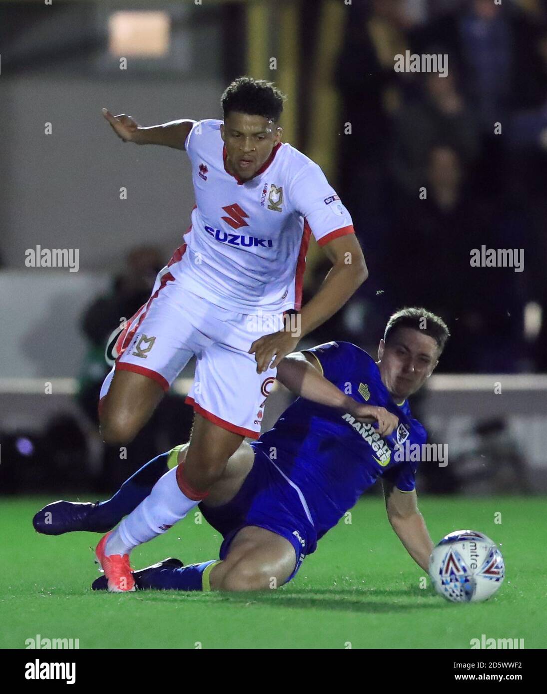 Milton Keynes Dons' Osman Sow, left battle for the ball with AFC ...