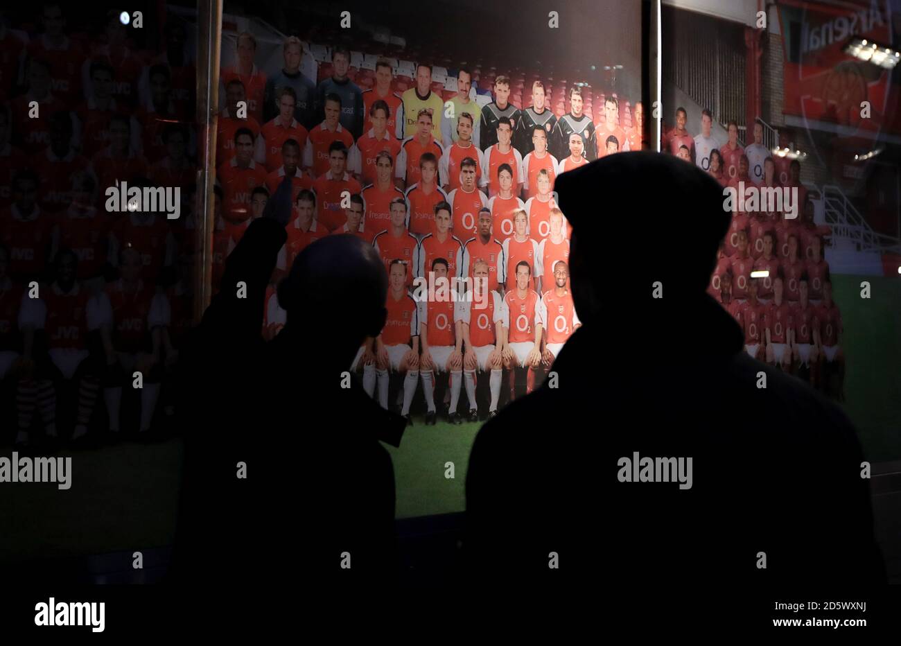 Fans look at a team group photo ahead of the match Stock Photo - Alamy