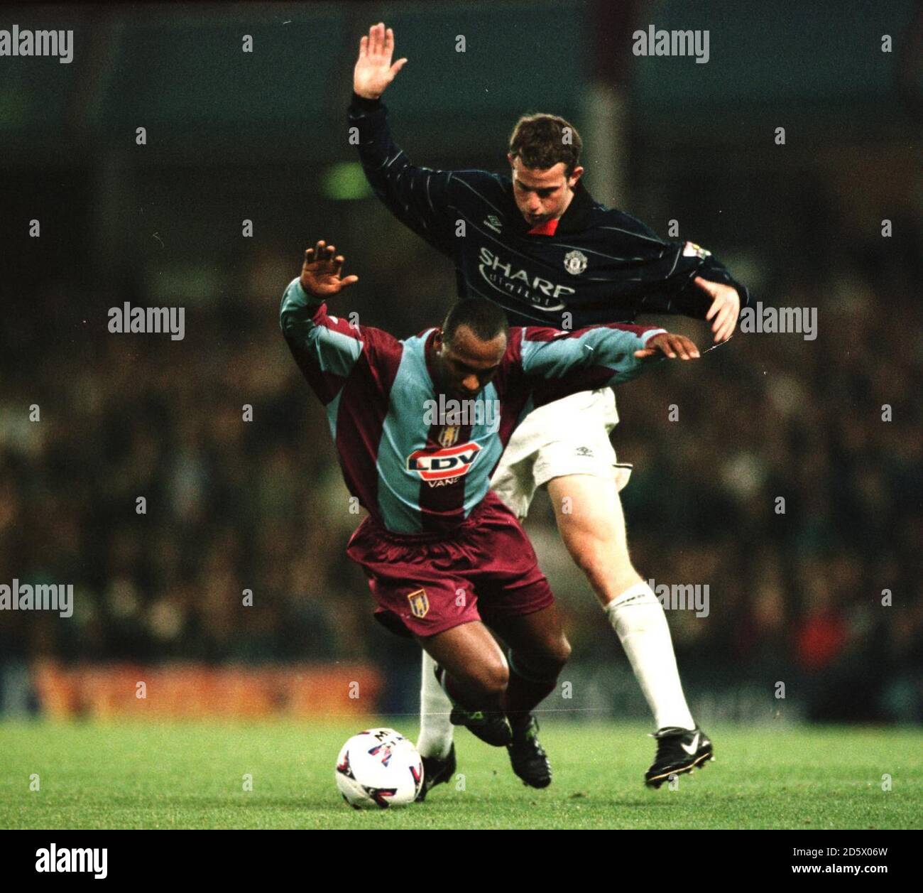 Aston Villa's Julian Joachim brought down by Manchester United's ...