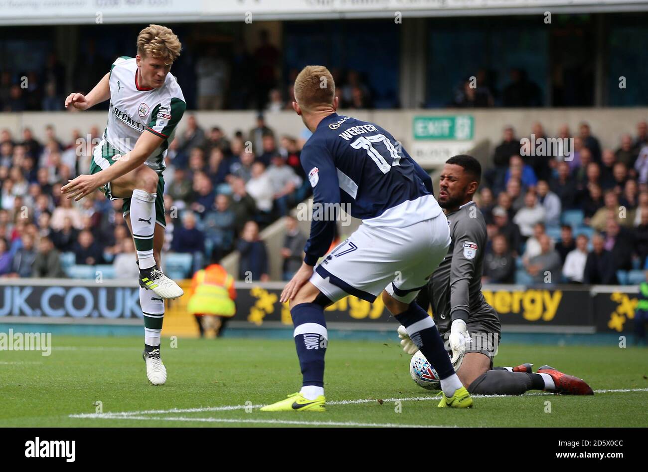 Millwall's Jordan Archer makes a save from and Barnsley's Cameron ...