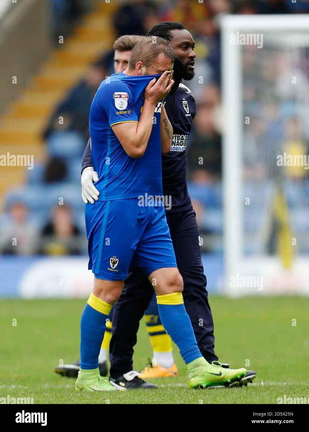 AFC Wimbledon's Dean Parrett goes off injured Stock Photo - Alamy