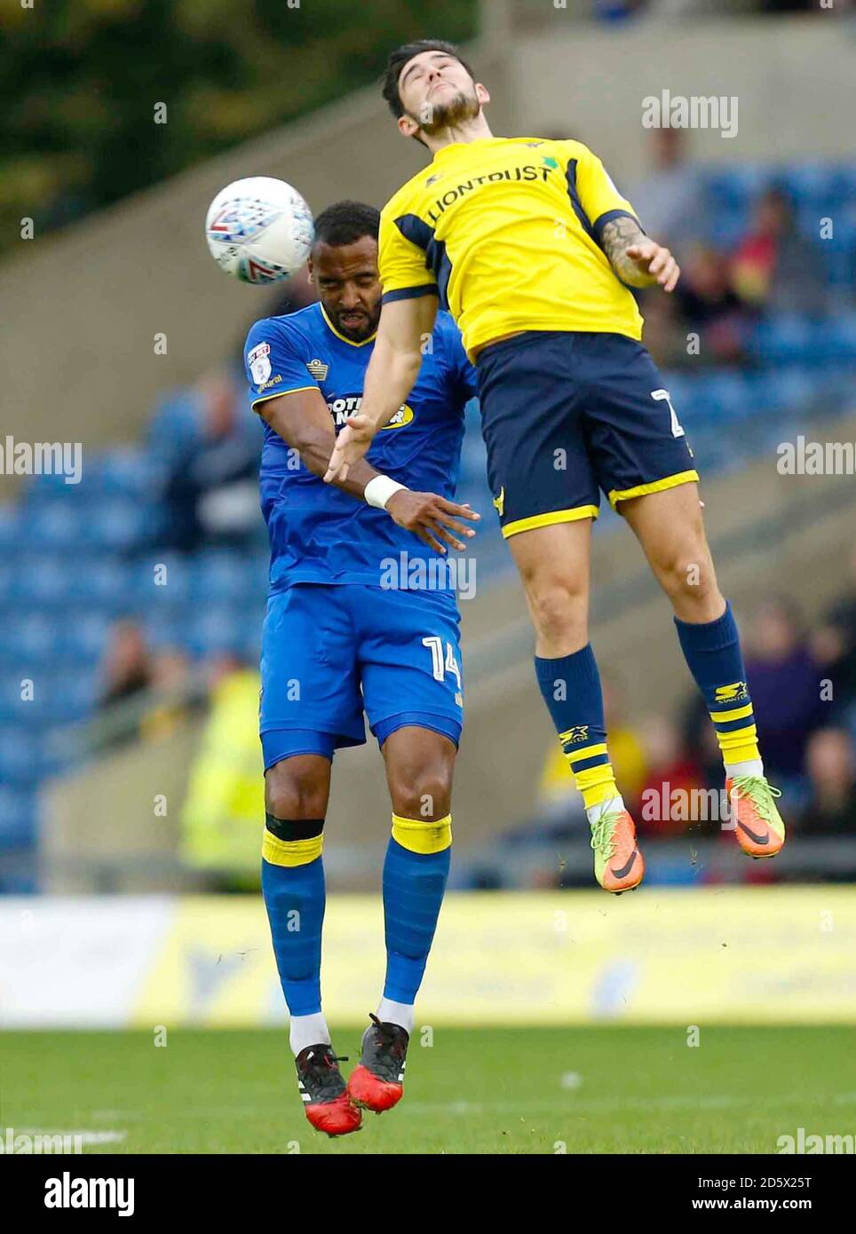 Oxford United's Christian Ribeiro and AFC Wimbledon's Liam Trotter ...